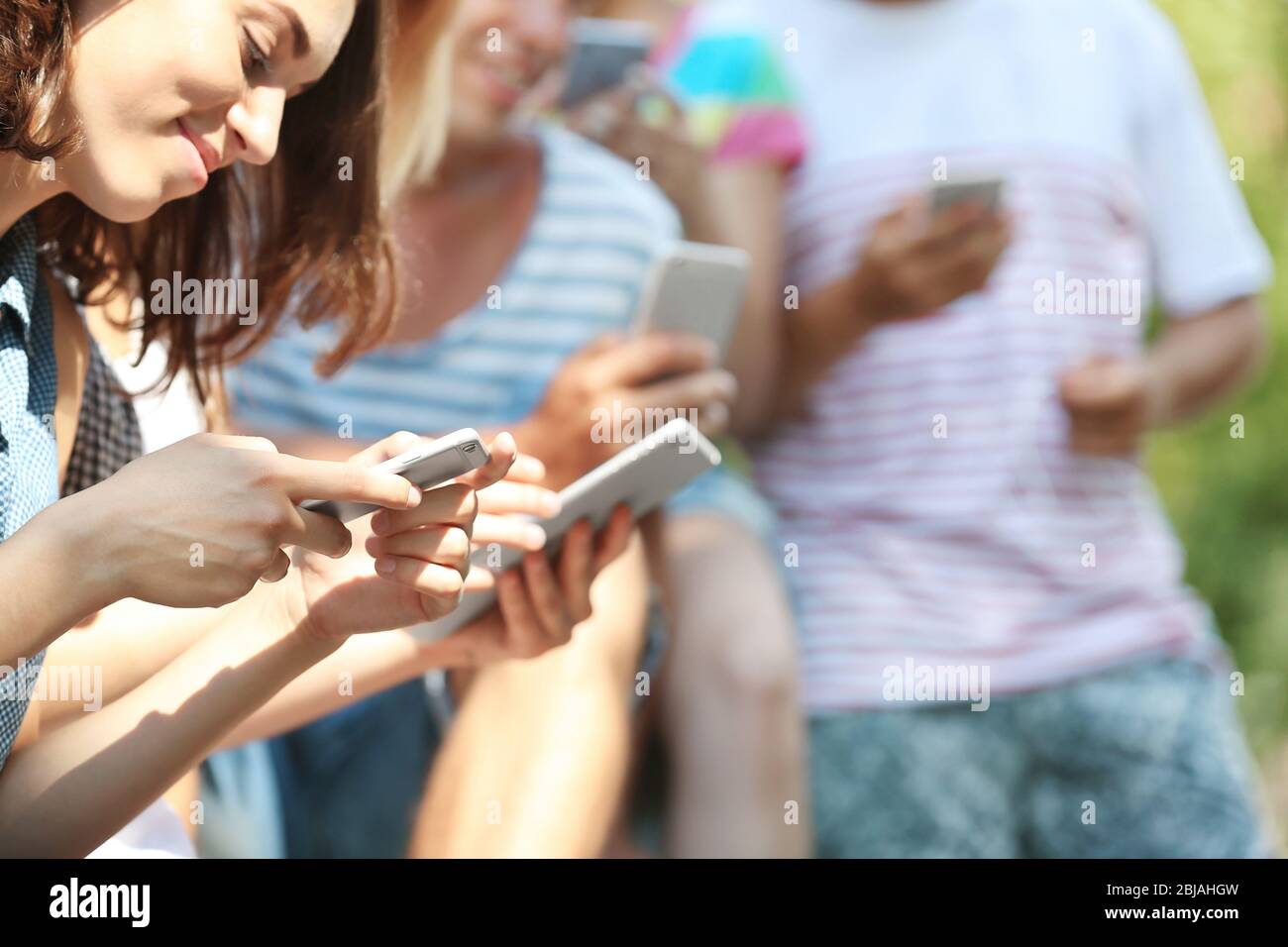 Teenagers with gadgets on street Stock Photo - Alamy