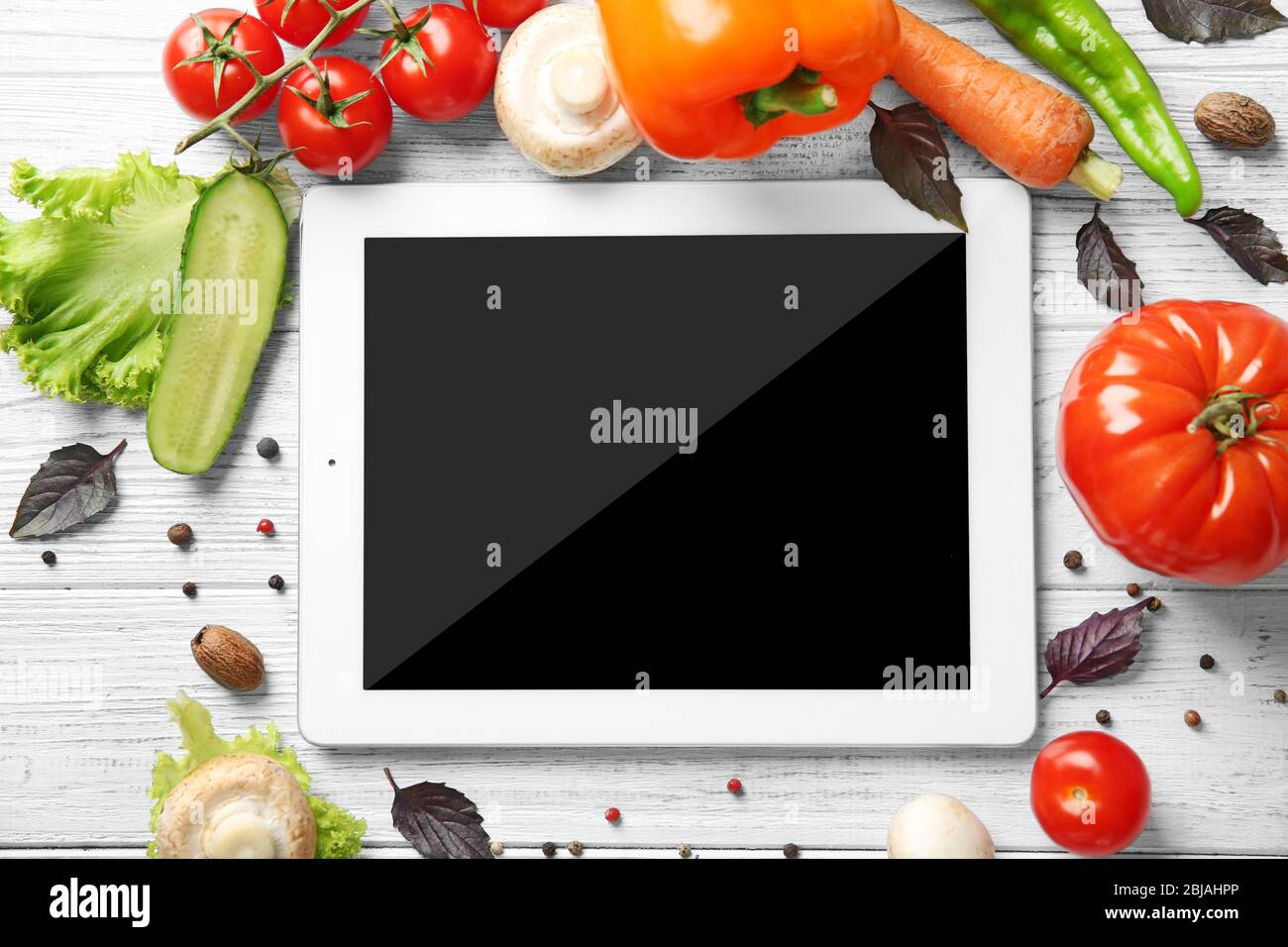 Fresh vegetables and tablet on wooden background, top view Stock Photo ...