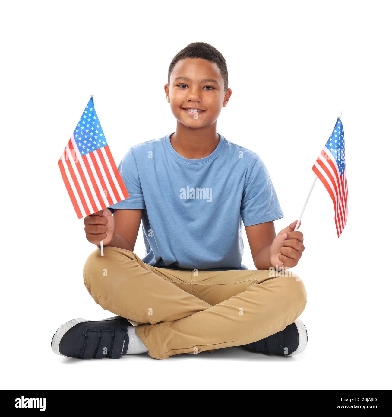 Boy holding American flags, isolated on white Stock Photo - Alamy