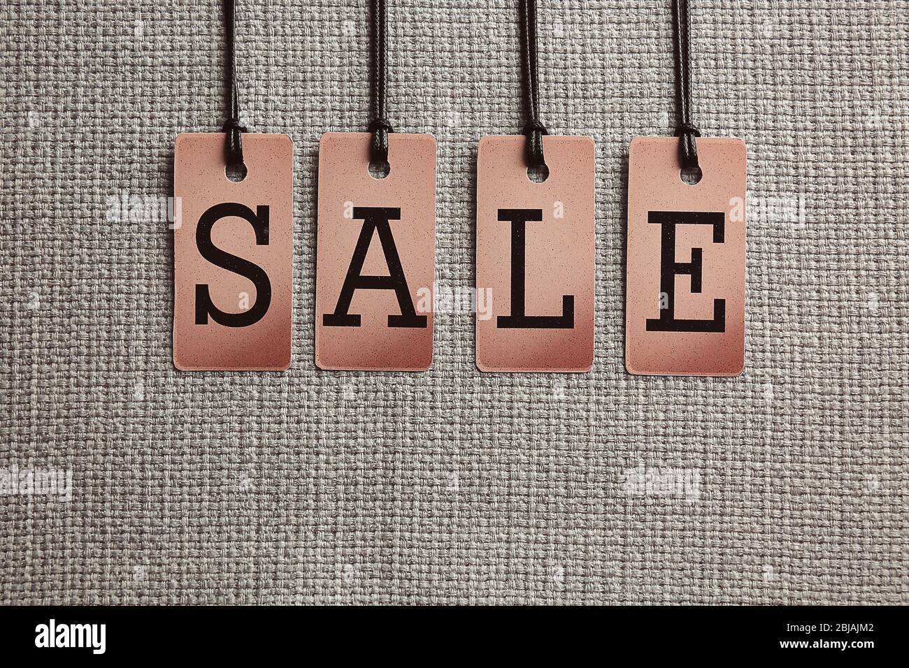 Sale labels on fabric background Stock Photo - Alamy