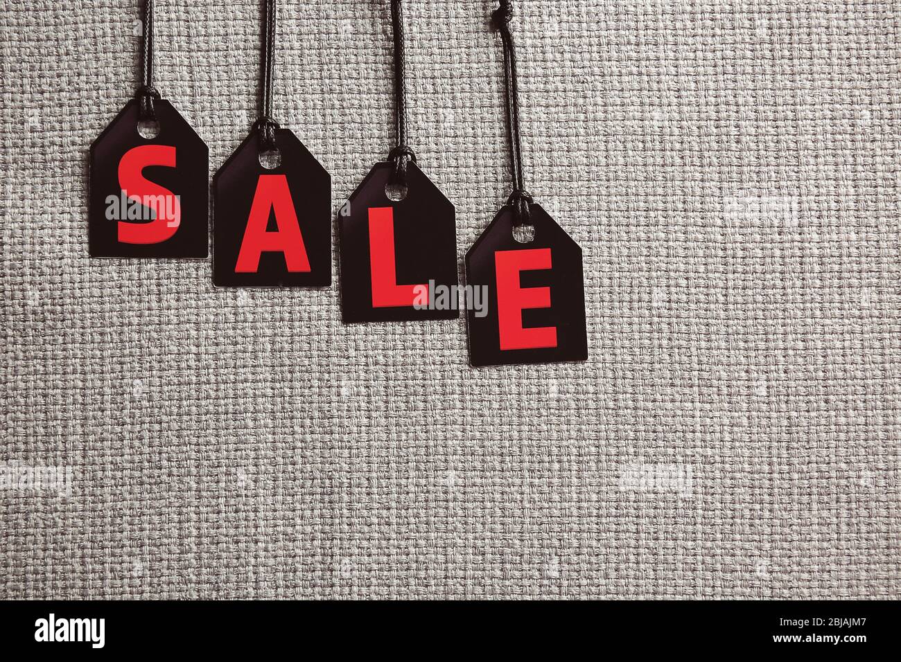 Sale labels on fabric background Stock Photo - Alamy