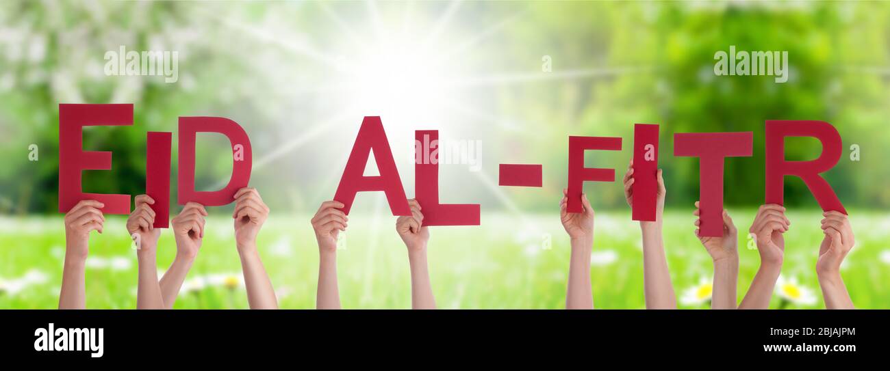 People Hands Holding Word Eid Al-Fitr, Grass Meadow Stock Photo - Alamy