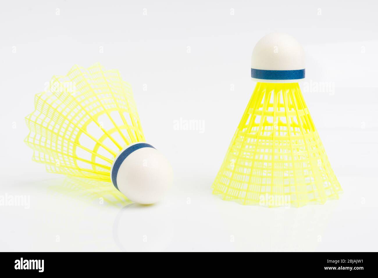 Yellow shuttlecock on white background Stock Photo - Alamy