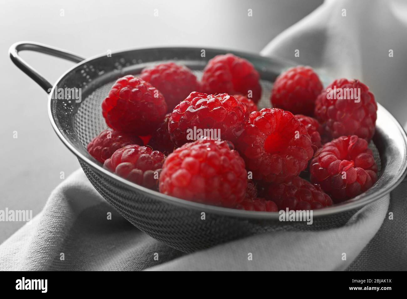 Fresh raspberry on sieve, closeup Stock Photo - Alamy