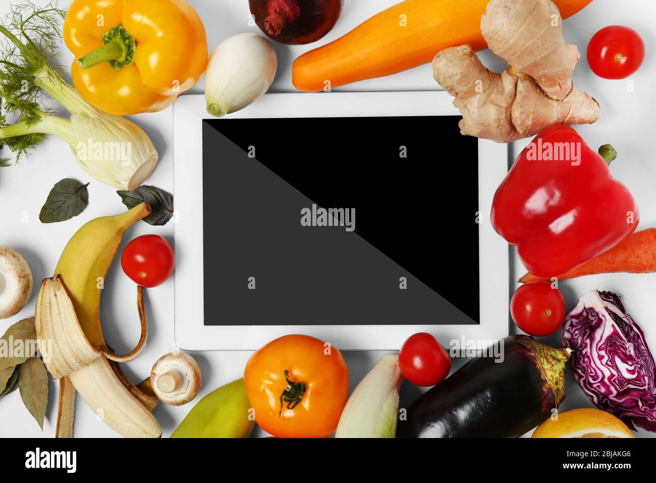 Vegetables and tablet on white background Stock Photo - Alamy