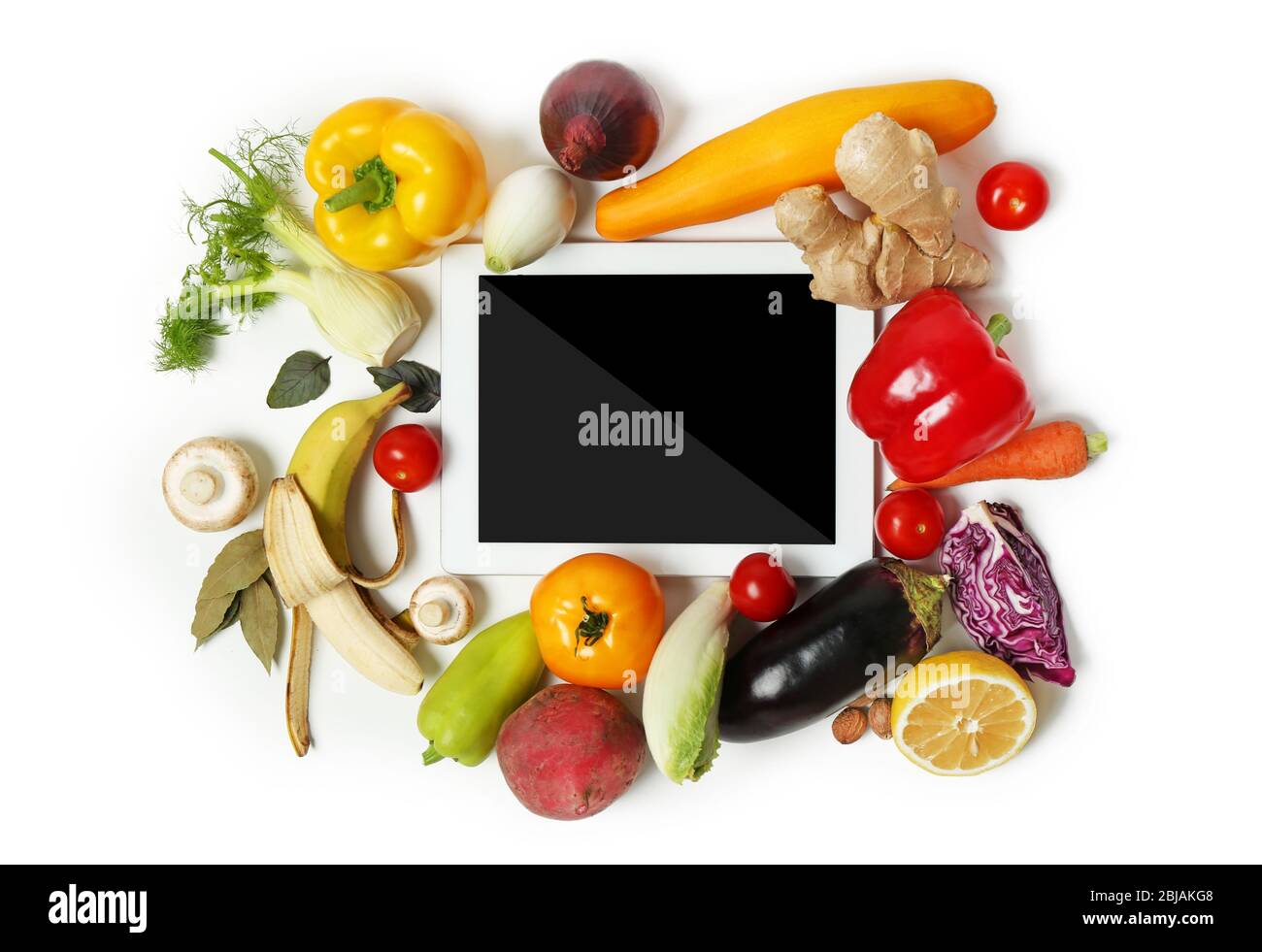 Vegetables and tablet on white background Stock Photo - Alamy