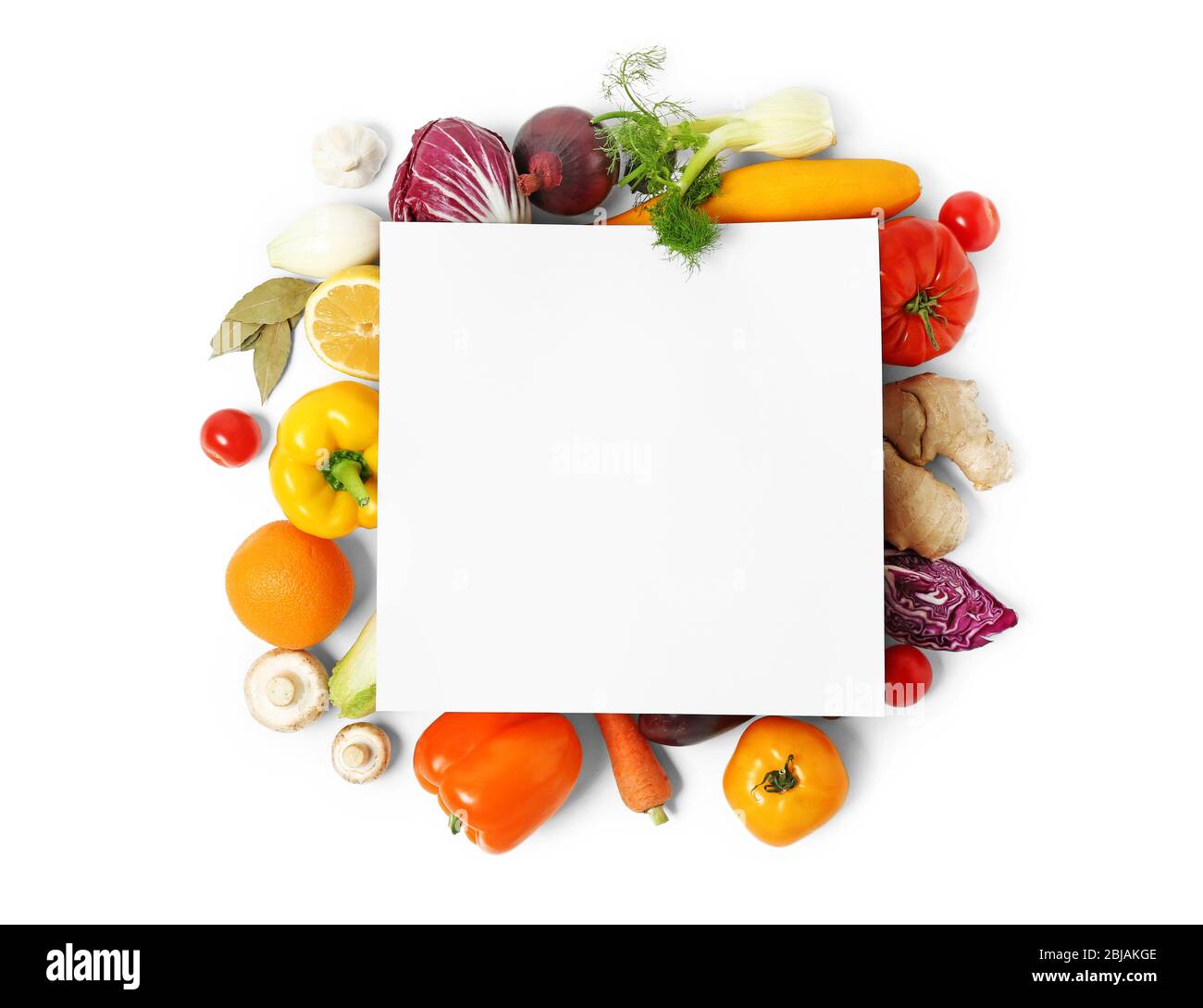 Vegetables and sheet of paper on white background Stock Photo - Alamy