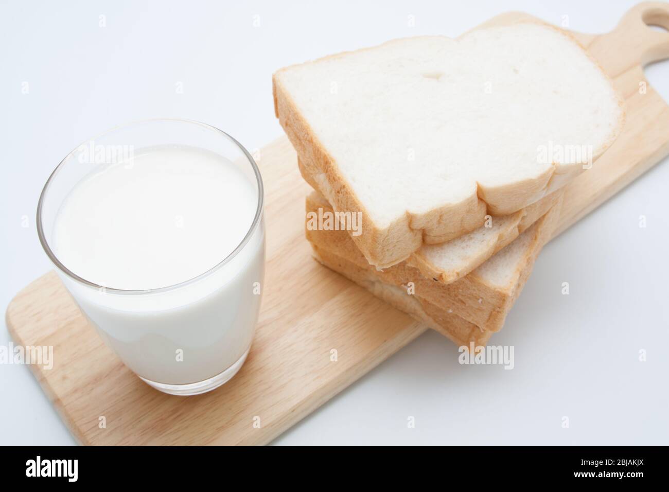 glass of milk and sliced bread on white background Stock Photo - Alamy