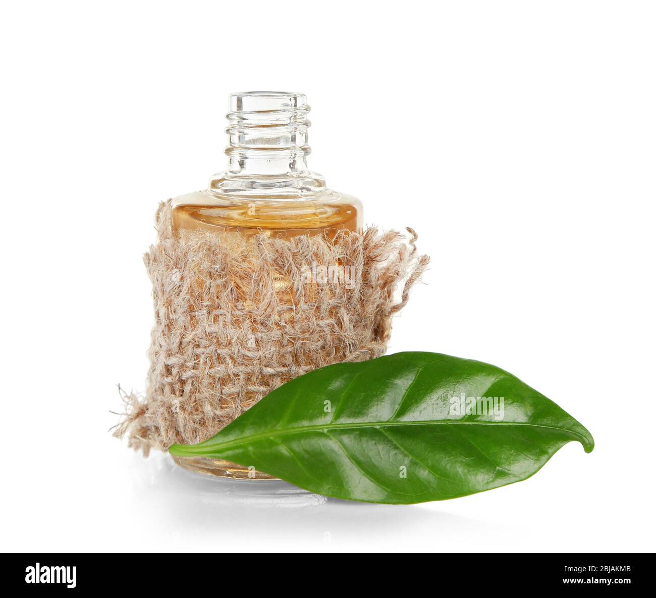 Tea oil in glass bottle with fresh leaves, isolated on white Stock ...