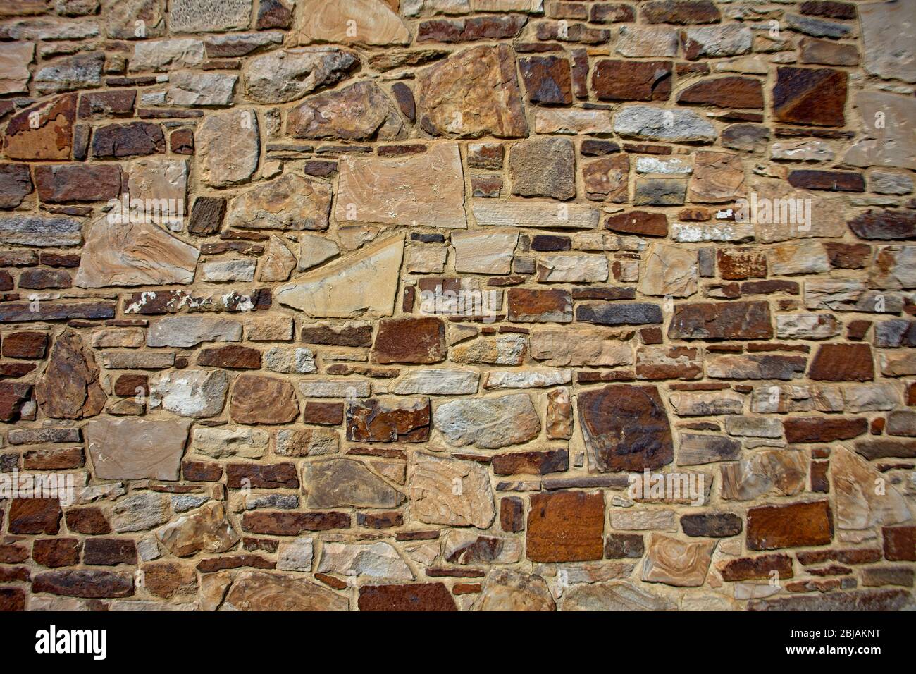 A modern stone wall made with mixed rock varieties. Northumberland, UK ...