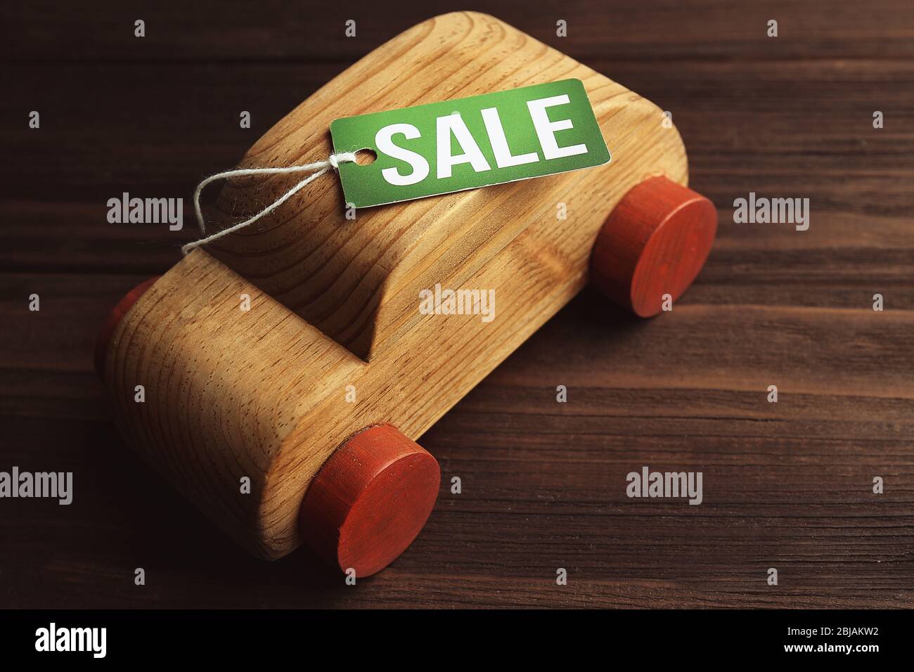 Sale label on wooden toy car Stock Photo - Alamy
