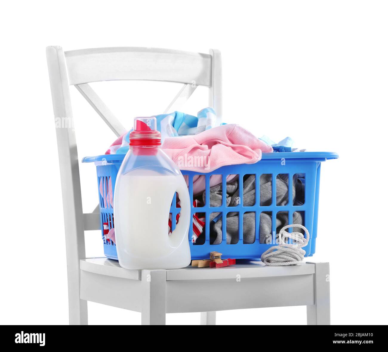 Blue plastic basket with baby laundry and cleanser on white background ...