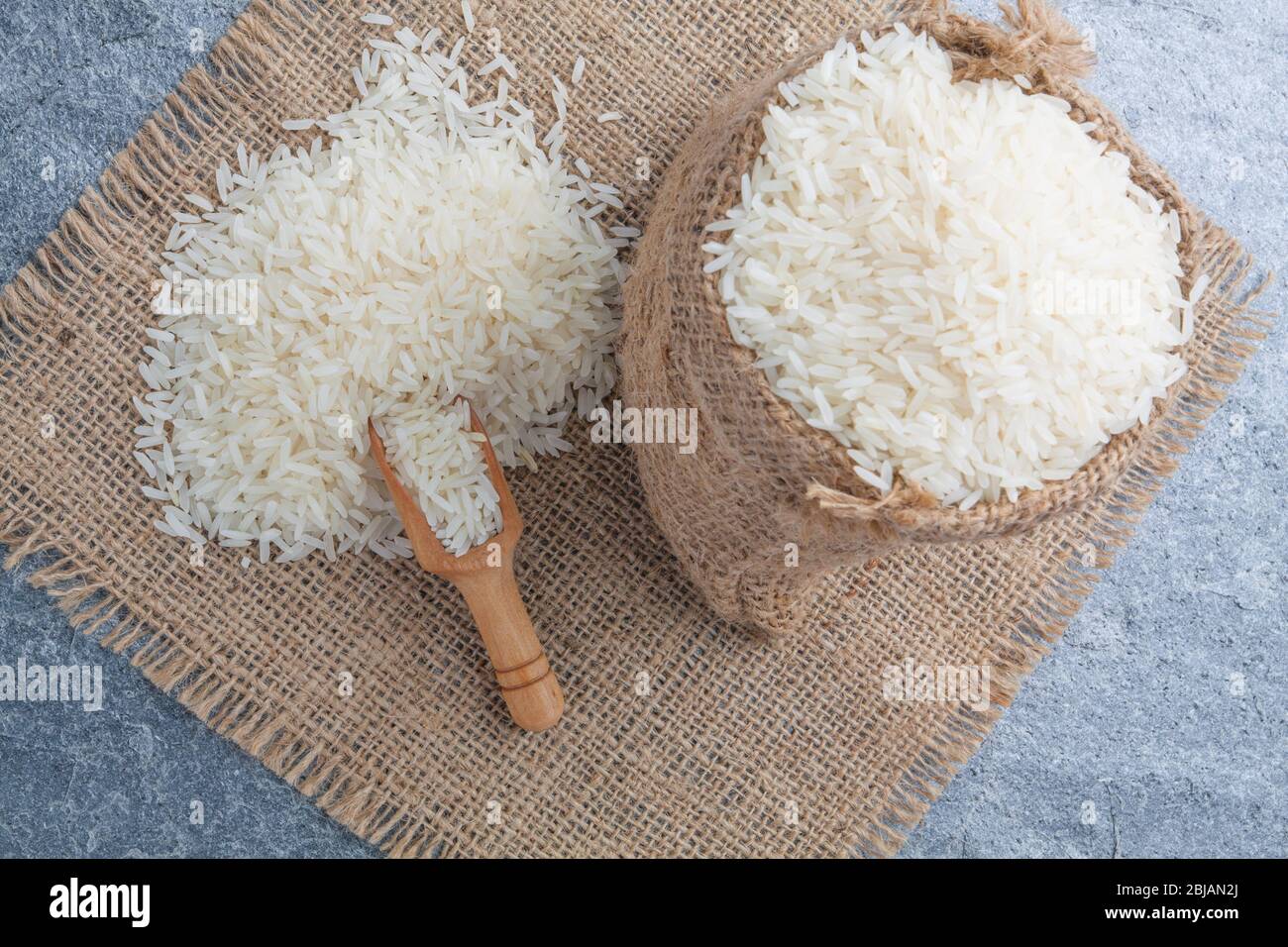thai fragrant jasmine rice in a spoon with gold spike on Sack Stock ...