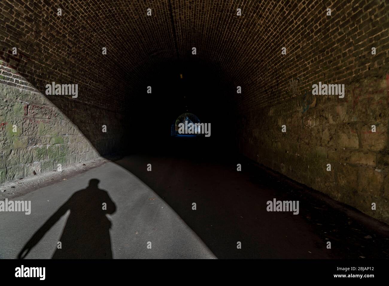 Shadow of a person, man, at the beginning of a tunnel, symbolic image ...