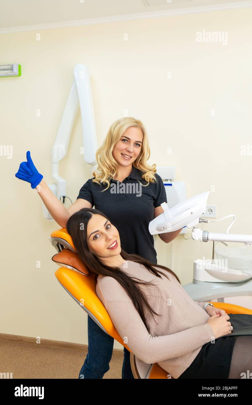 Beautiful female model advertising teeth whitening in a dental clinic ...