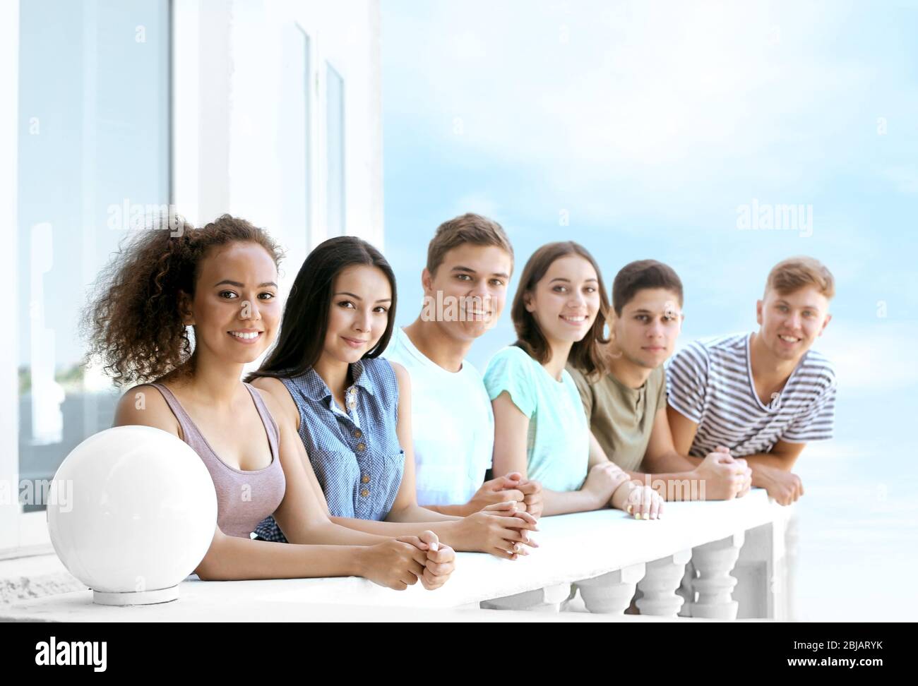 Happy friends on balcony Stock Photo - Alamy