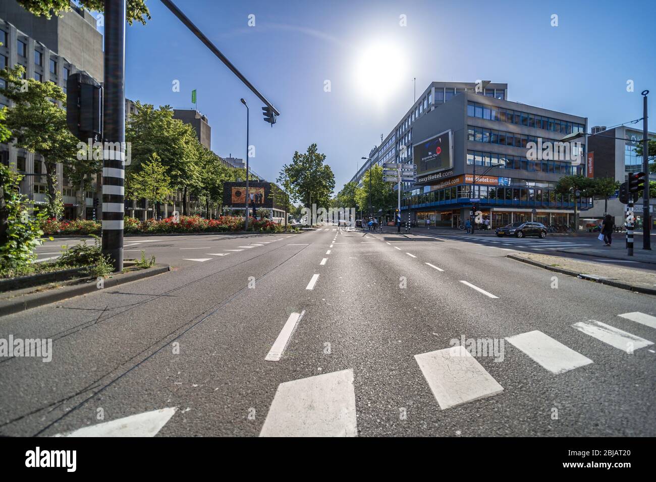 Trafficlights and billboards downtown of Rotterdam, people walking in ...