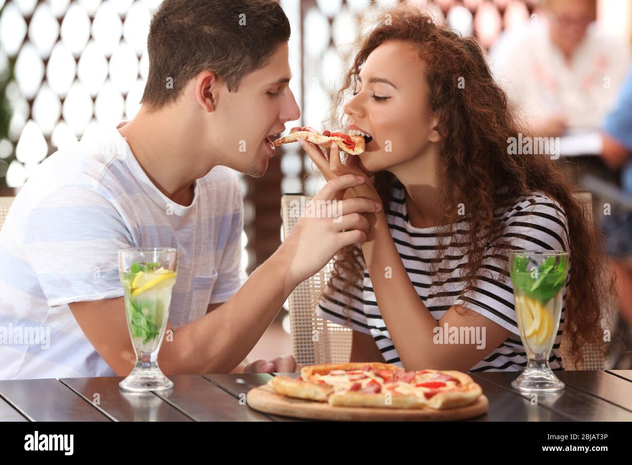 Lovely couple eating pizza Stock Photo - Alamy