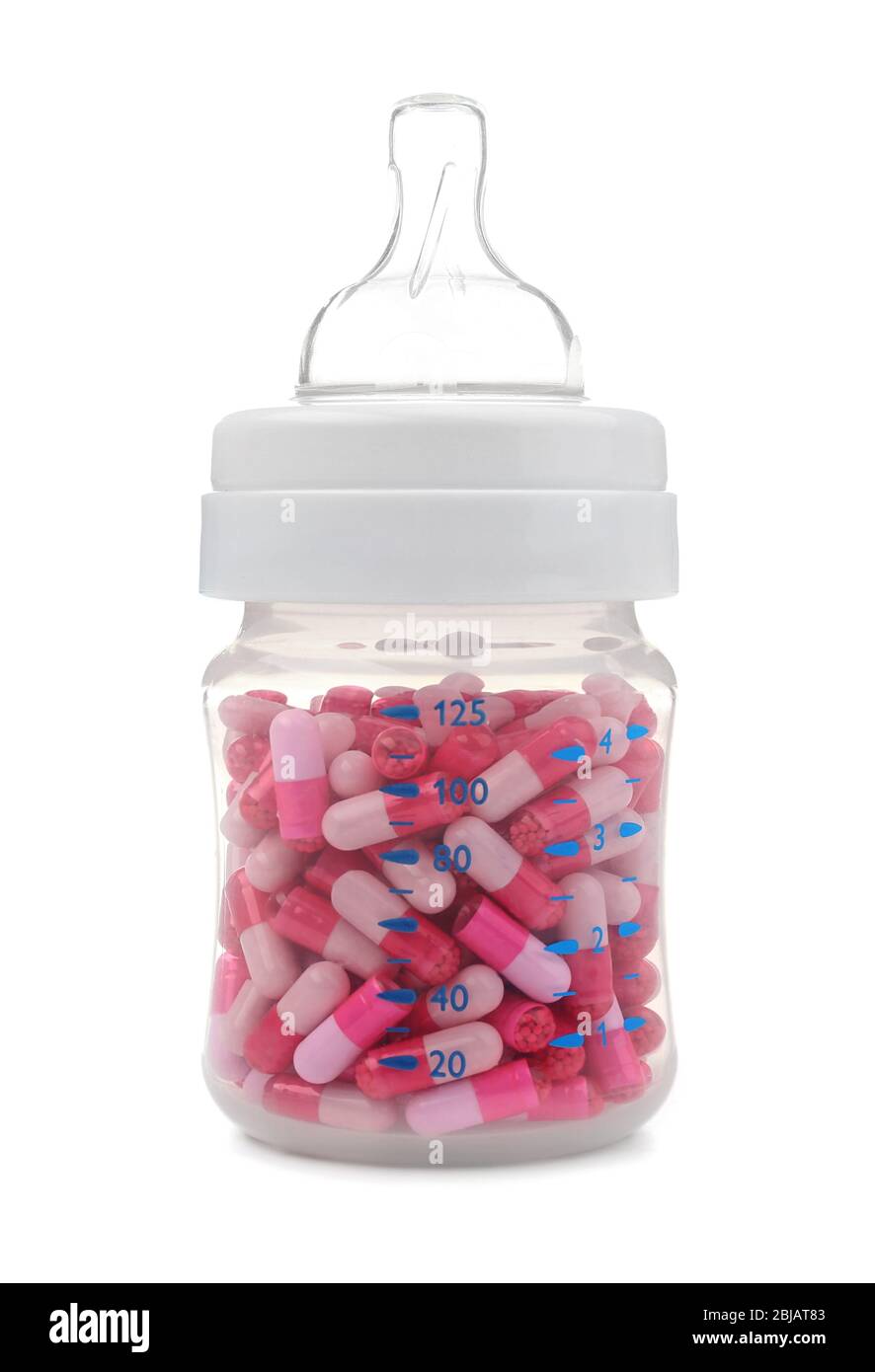 Baby bottle full of colourful pills isolated on white Stock Photo - Alamy