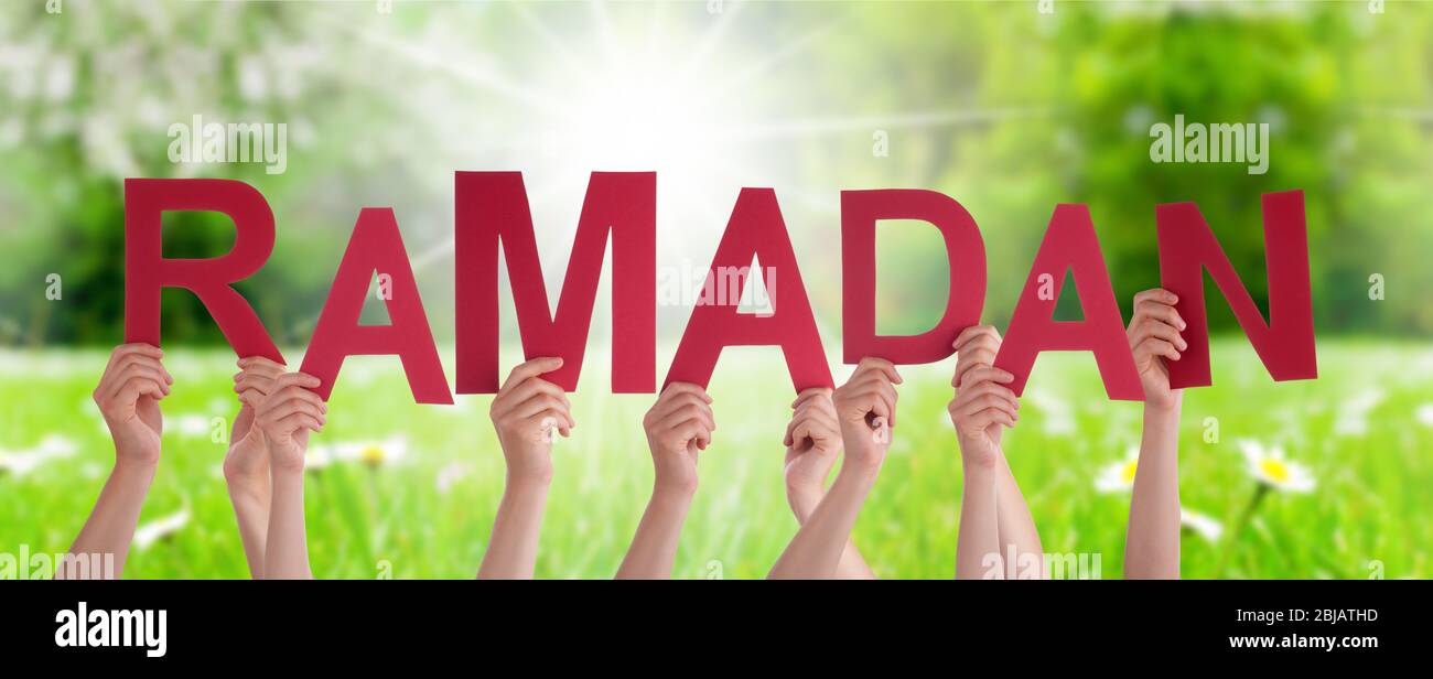 People Hands Holding Word Ramadan, Grass Meadow Stock Photo - Alamy