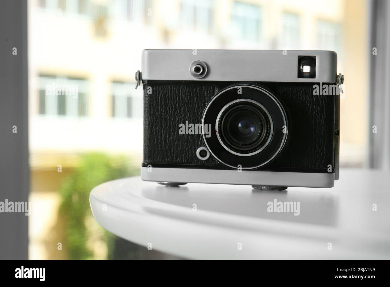 Vintage camera on a white table hi-res stock photography and images - Alamy
