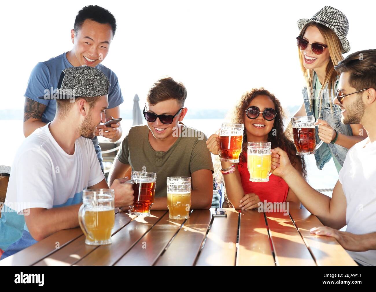 Group of friends hanging out together outdoors Stock Photo - Alamy