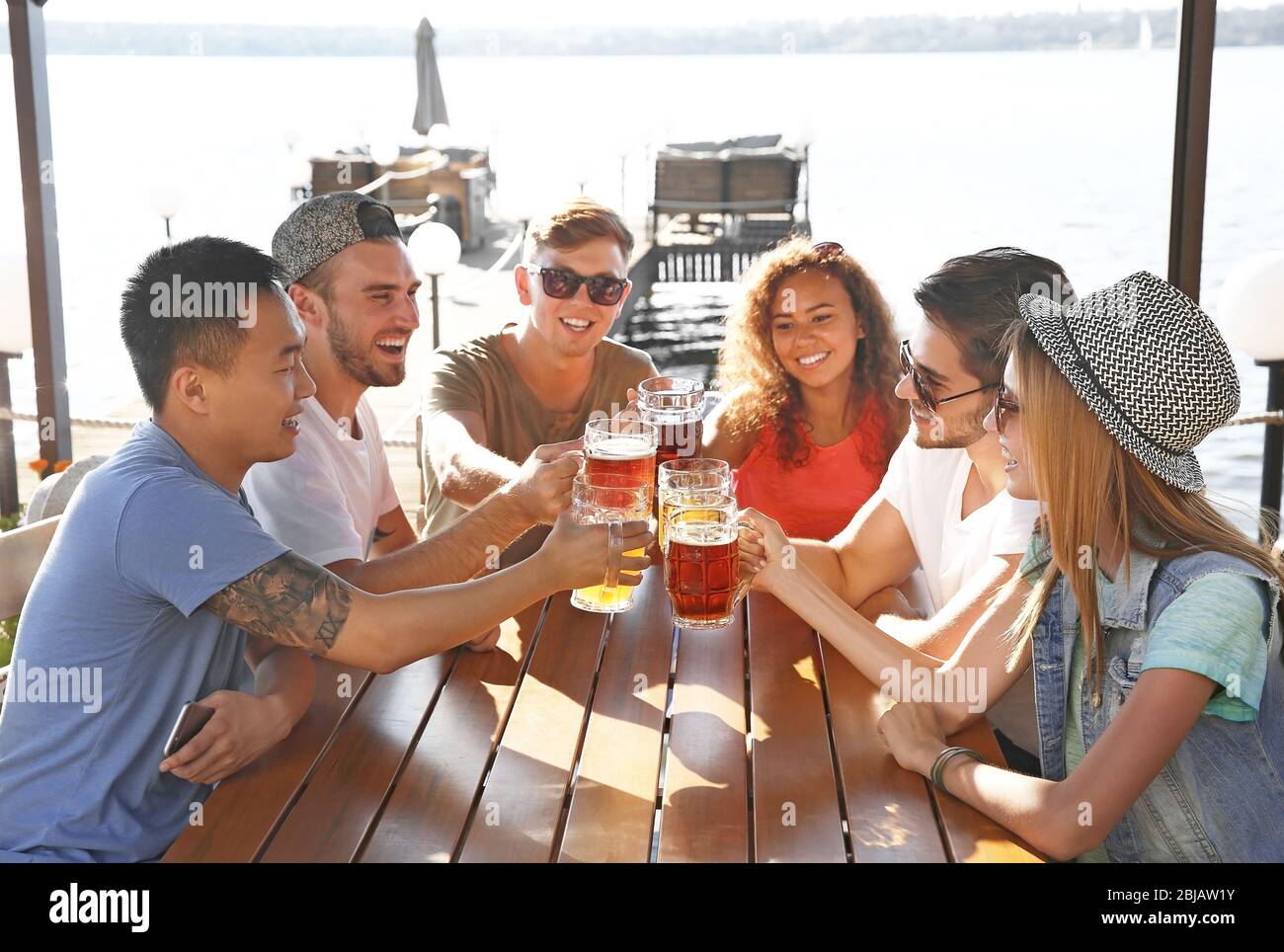 Group of friends hanging out together outdoors Stock Photo - Alamy