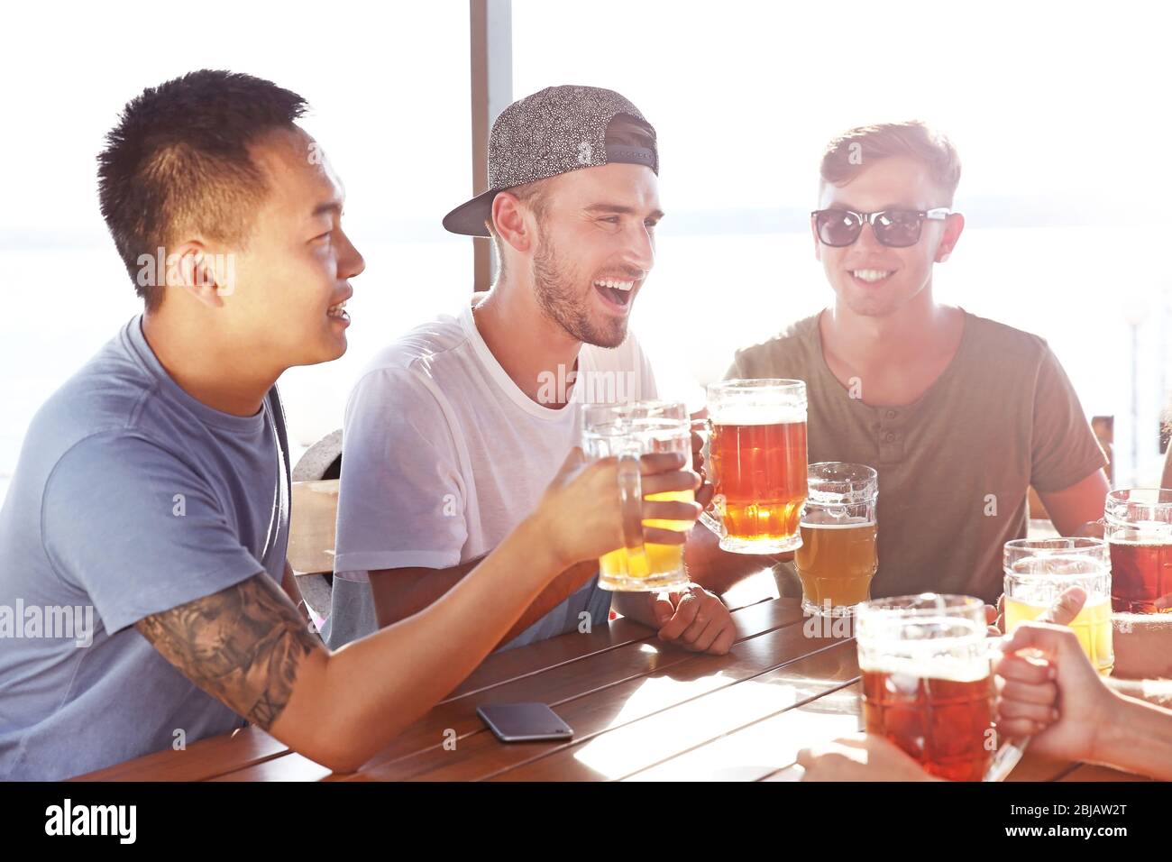 Group of friends hanging out together outdoors Stock Photo - Alamy