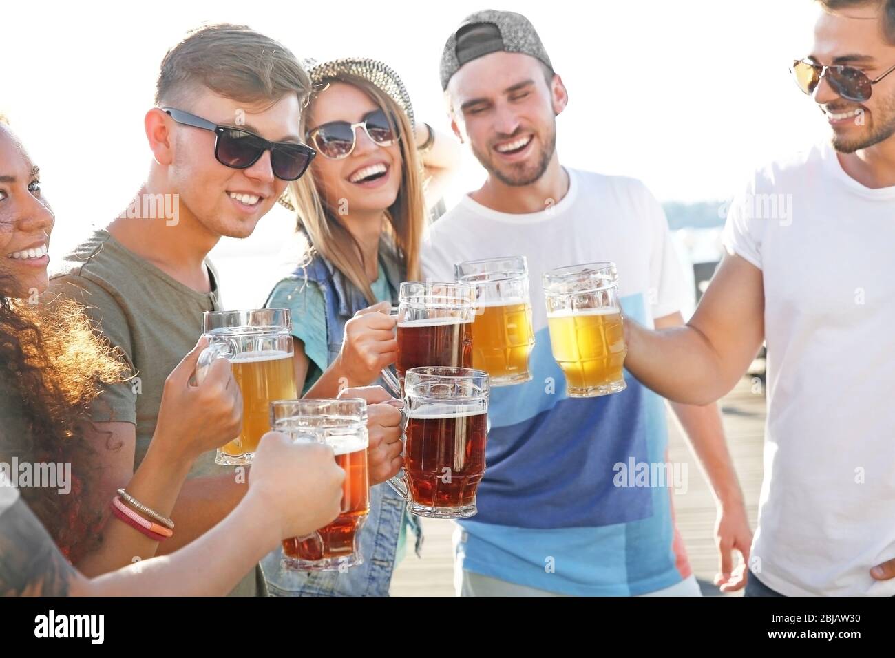 Group of friends hanging out together outdoors Stock Photo - Alamy