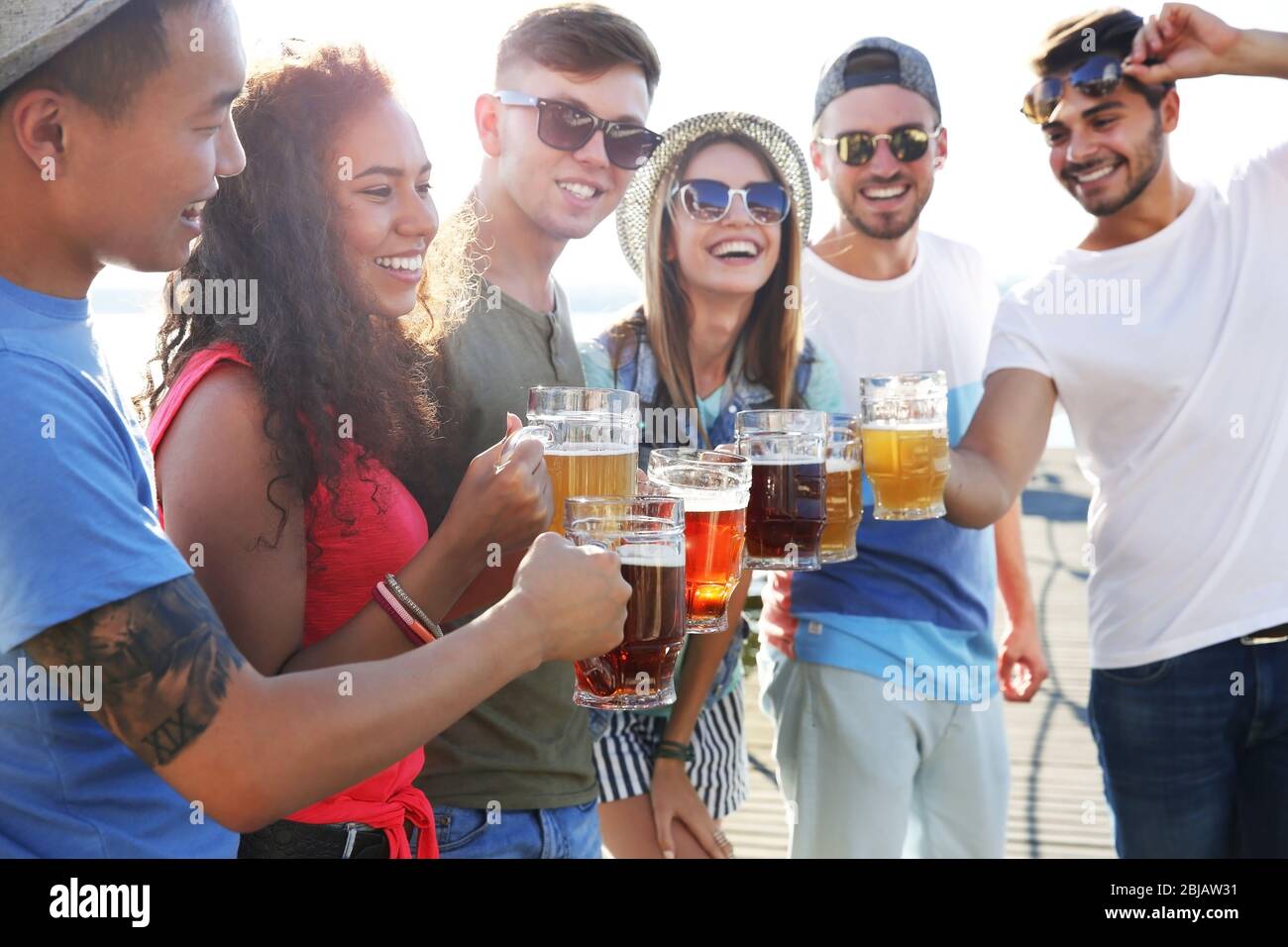 Group of friends hanging out together outdoors Stock Photo - Alamy