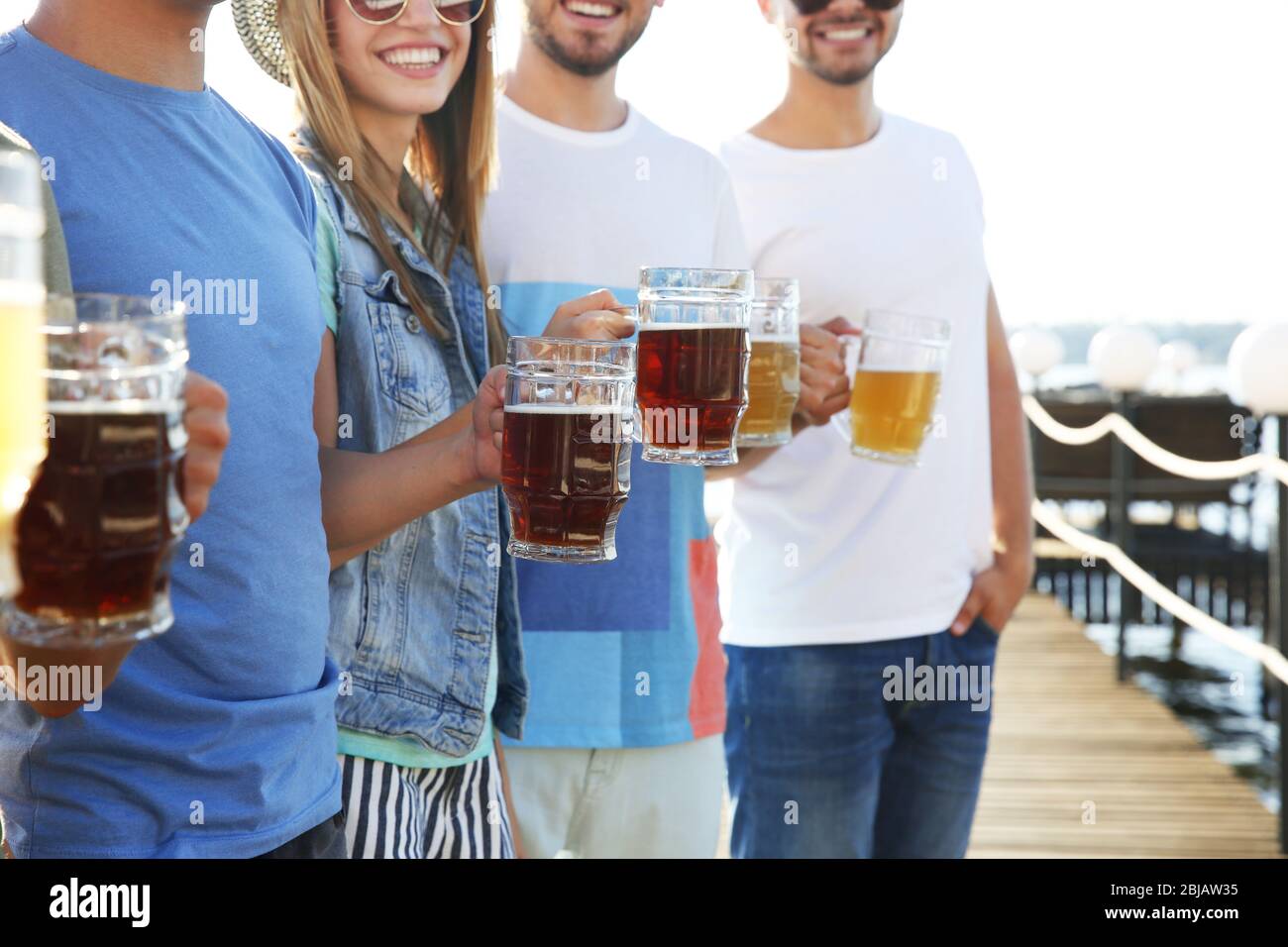 Group of friends hanging out together outdoors Stock Photo - Alamy