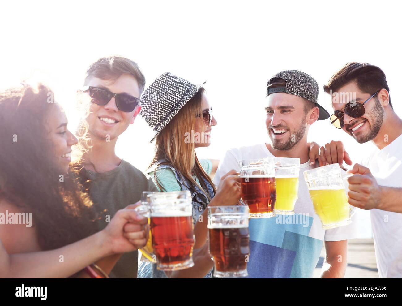 Group of friends hanging out together outdoors Stock Photo - Alamy