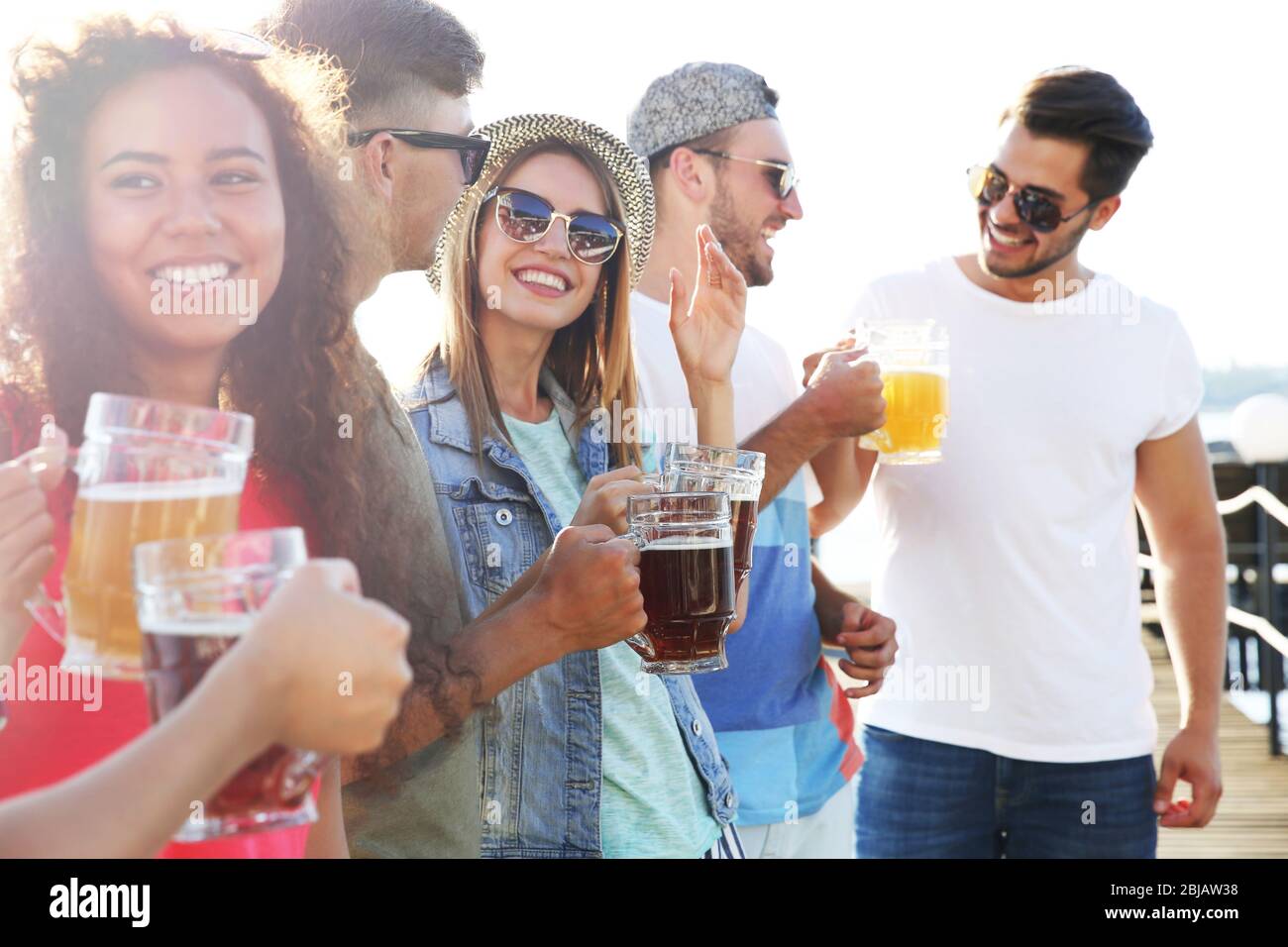 Group of friends hanging out together outdoors Stock Photo - Alamy