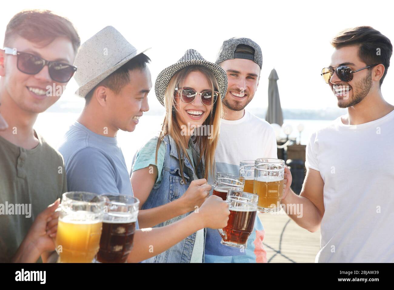 Group of friends hanging out together outdoors Stock Photo - Alamy