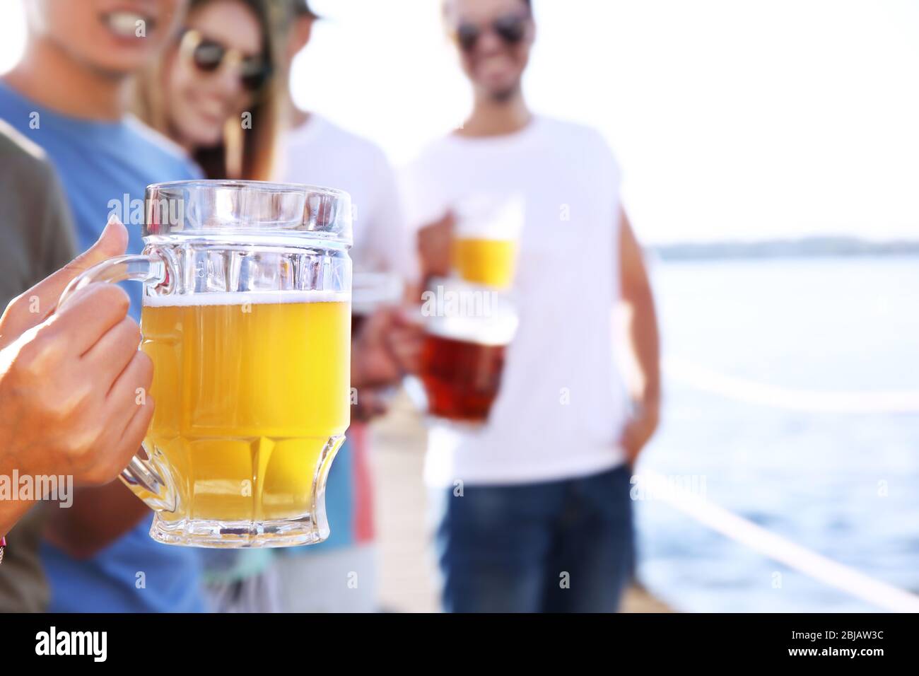 Group of friends hanging out together outdoors Stock Photo - Alamy