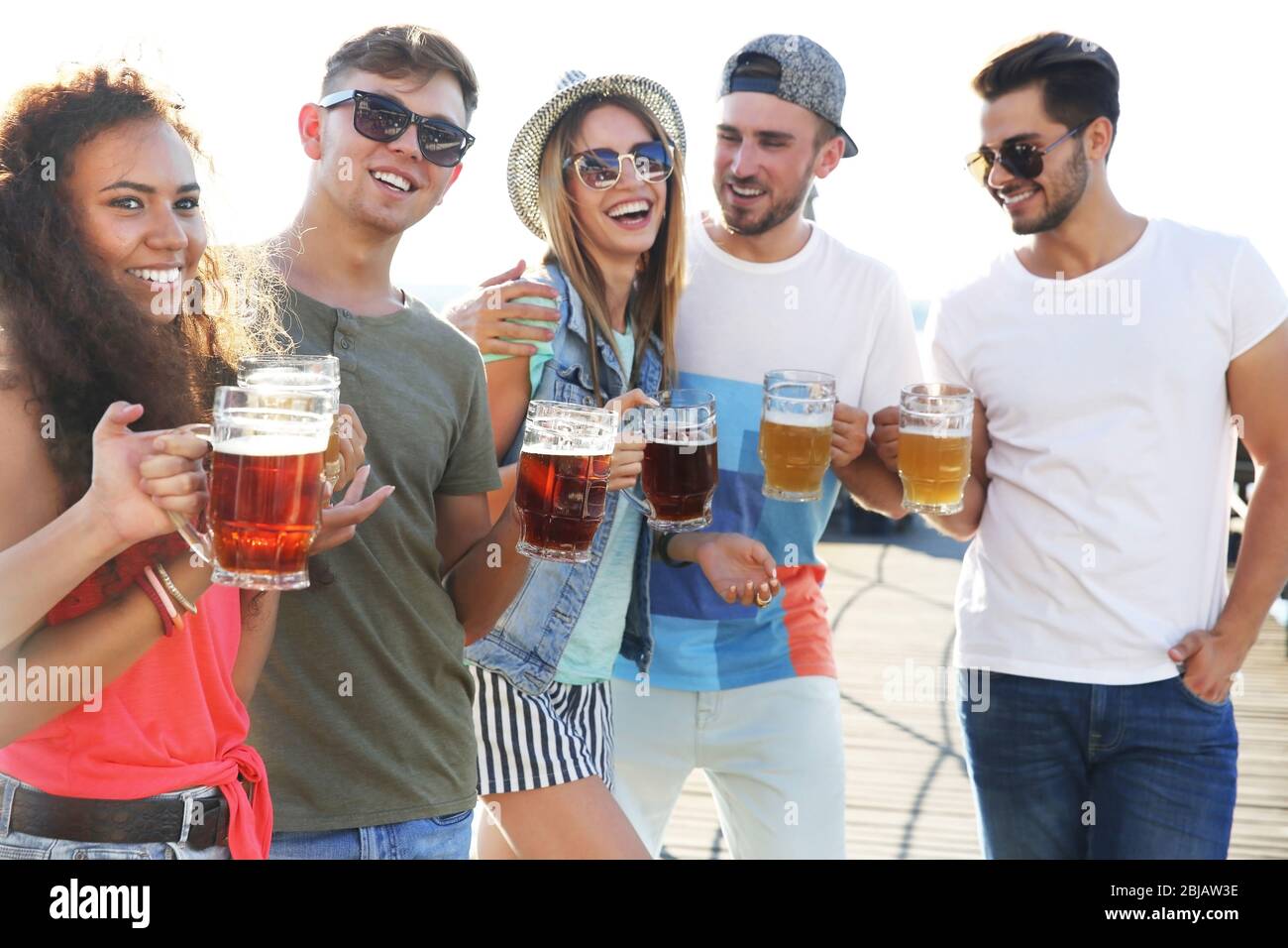 Group of friends hanging out together outdoors Stock Photo - Alamy
