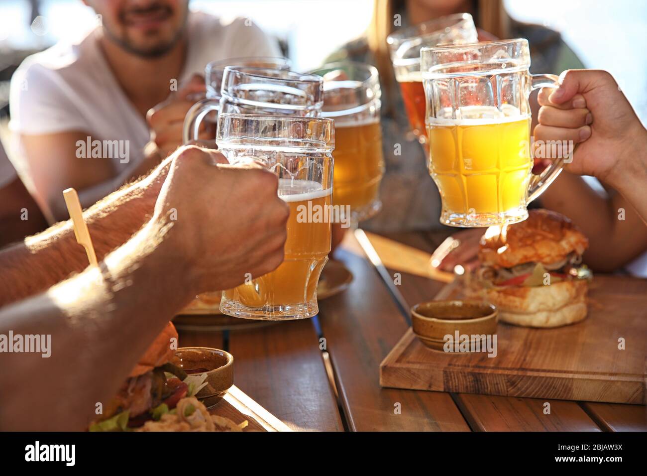 Group of friends drinking beer outdoors Stock Photo - Alamy