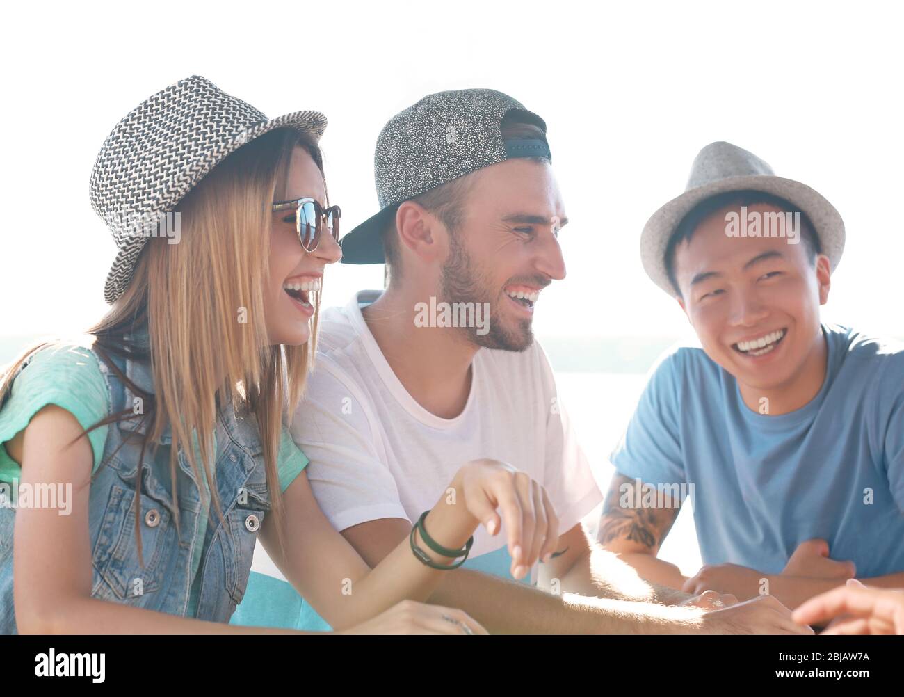 Group of friends hanging out together outdoors Stock Photo - Alamy