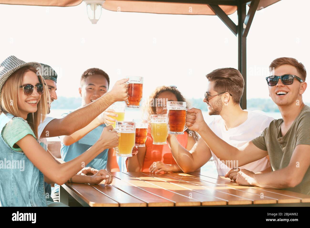 Group of friends hanging out together outdoors Stock Photo - Alamy