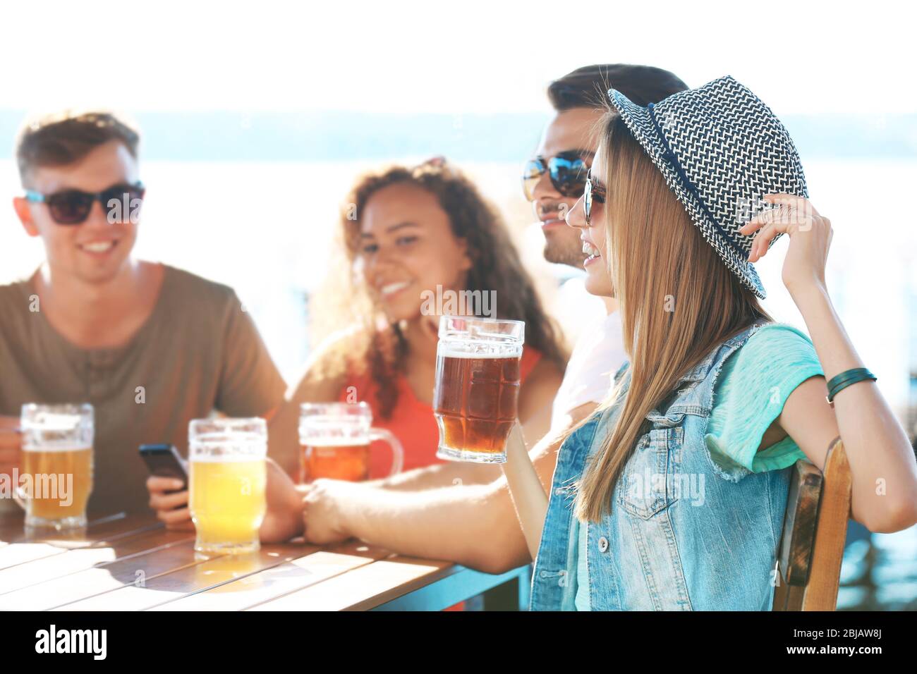 Group of friends hanging out together outdoors Stock Photo - Alamy