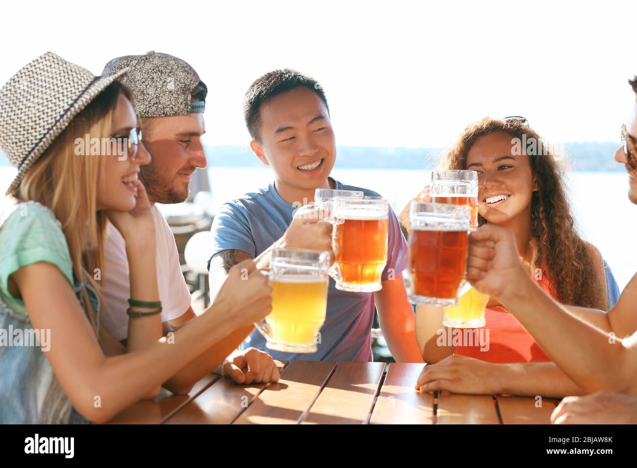 Group of friends hanging out together outdoors Stock Photo - Alamy