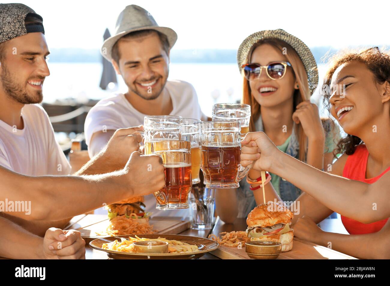 Group of friends hanging out together outdoors Stock Photo - Alamy
