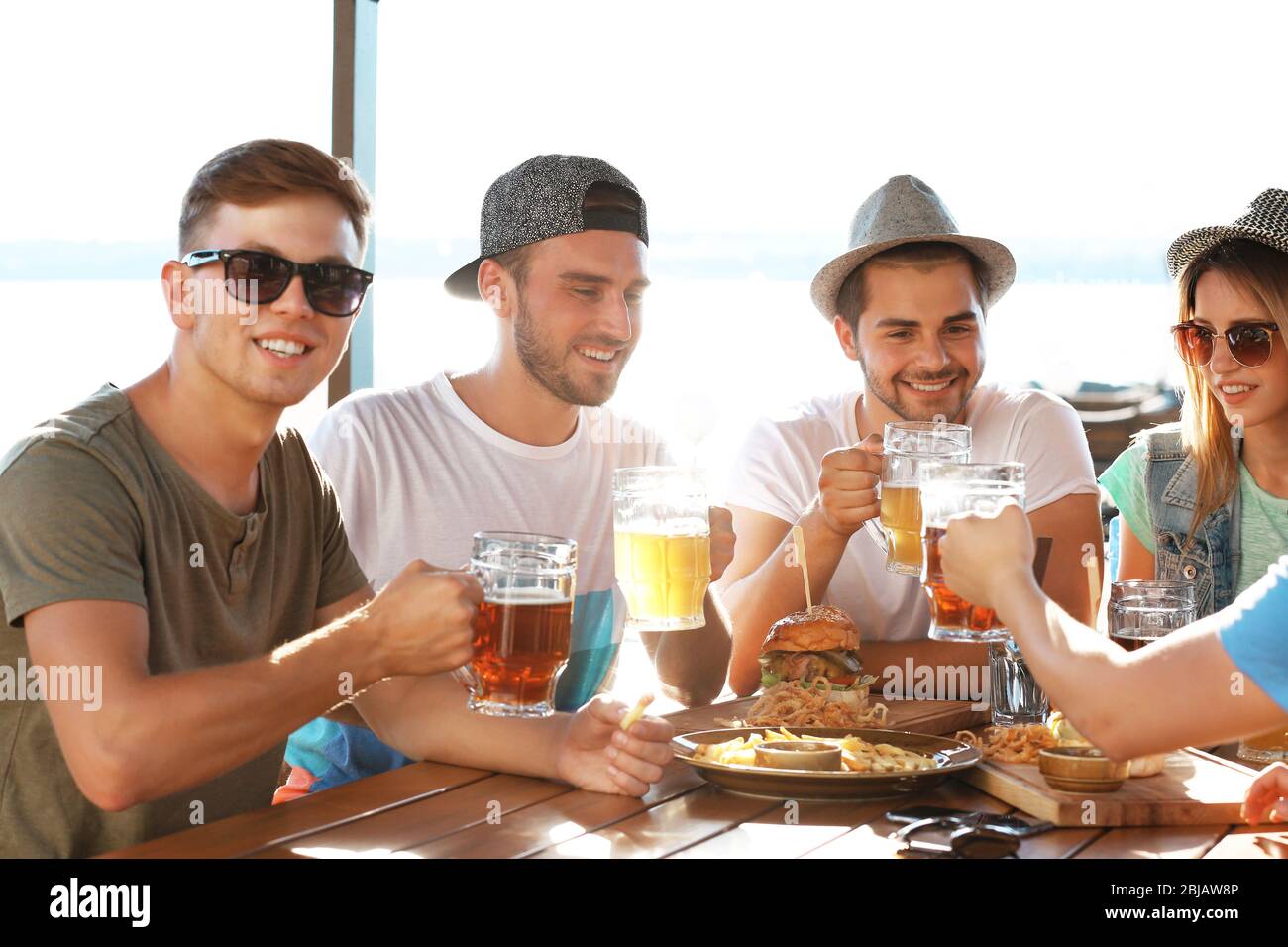 Group of friends hanging out together outdoors Stock Photo - Alamy