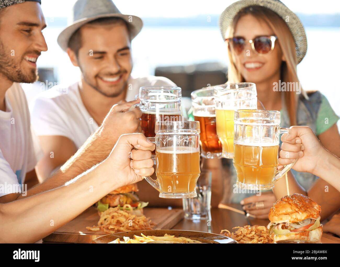 Group of friends hanging out together outdoors Stock Photo - Alamy