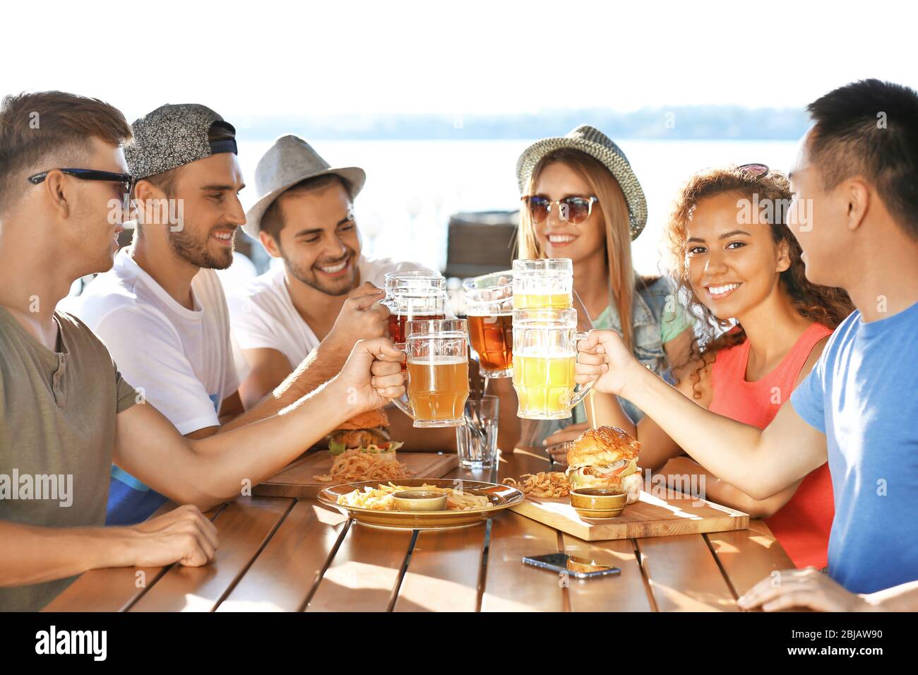 Group of friends hanging out together outdoors Stock Photo - Alamy