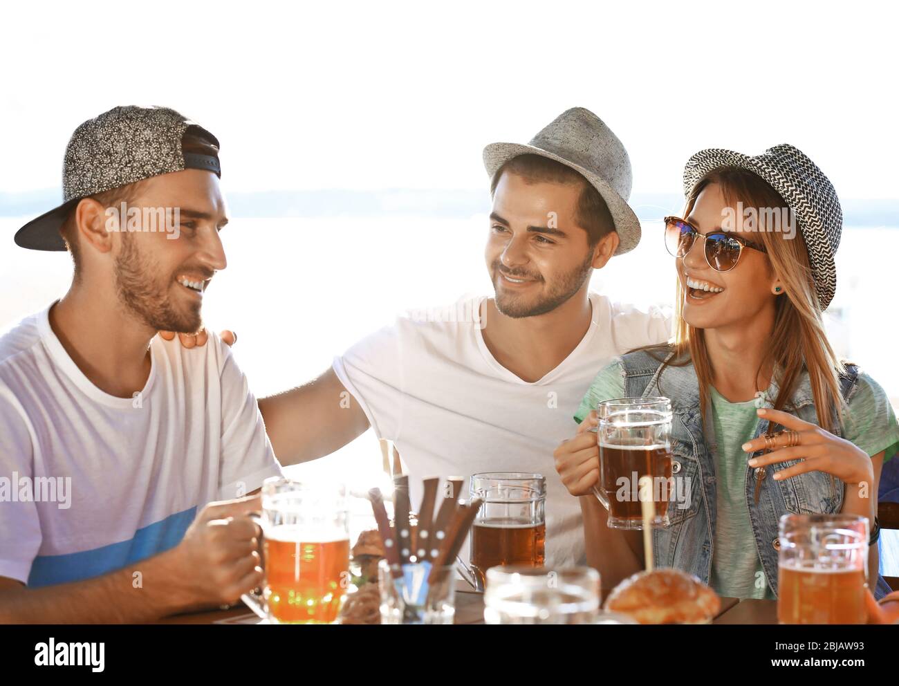 Group of friends hanging out together outdoors Stock Photo - Alamy
