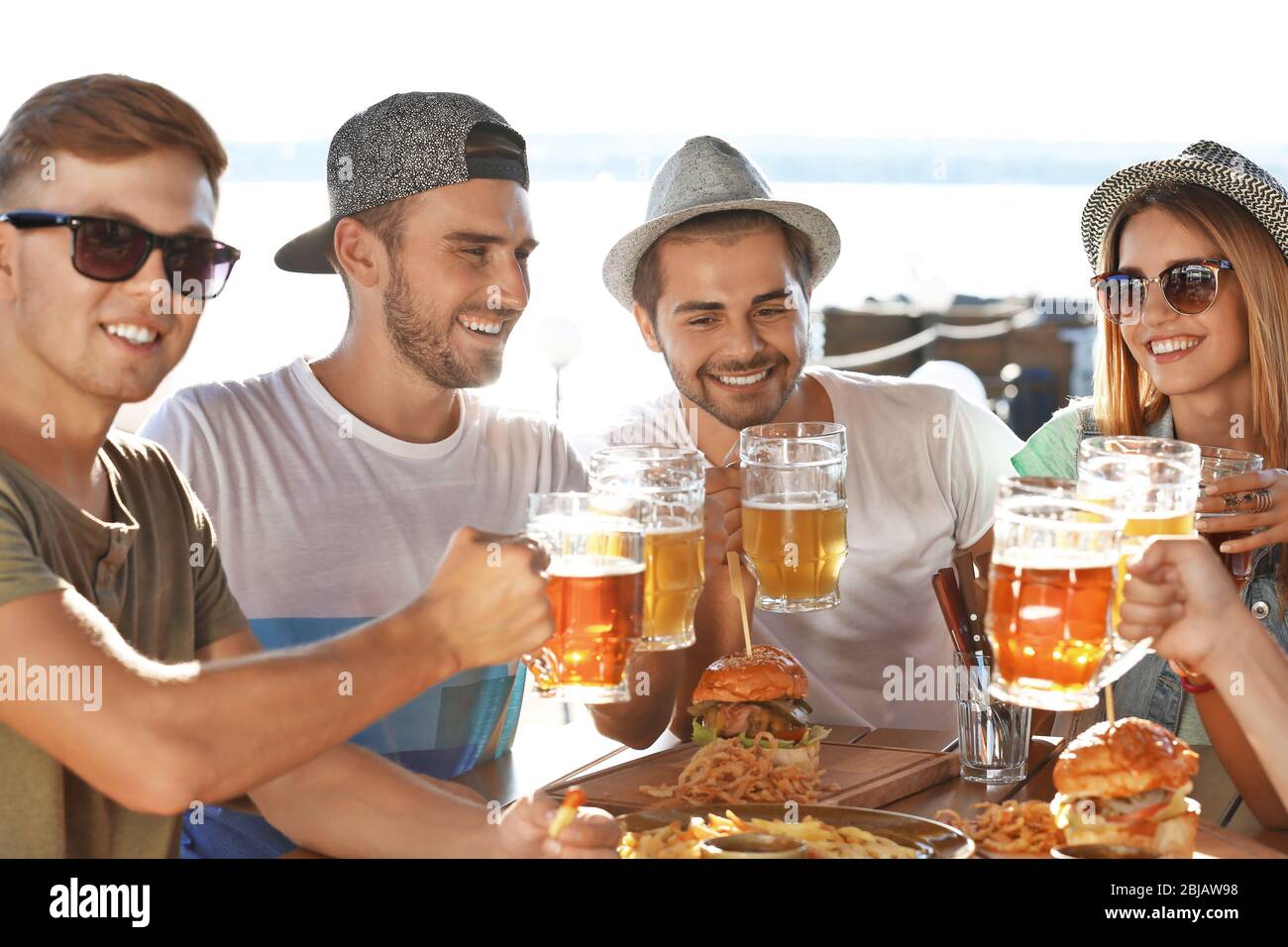 Group of friends hanging out together outdoors Stock Photo - Alamy