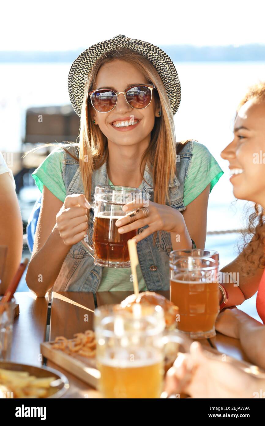 Female friends having glass beer hi-res stock photography and images ...