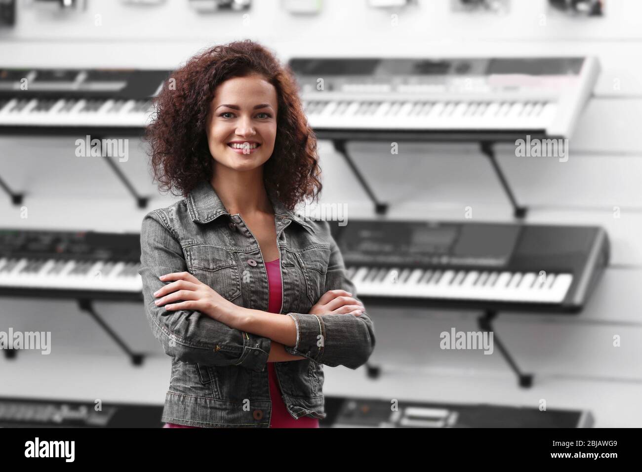 Beautiful girl in music shop Stock Photo - Alamy