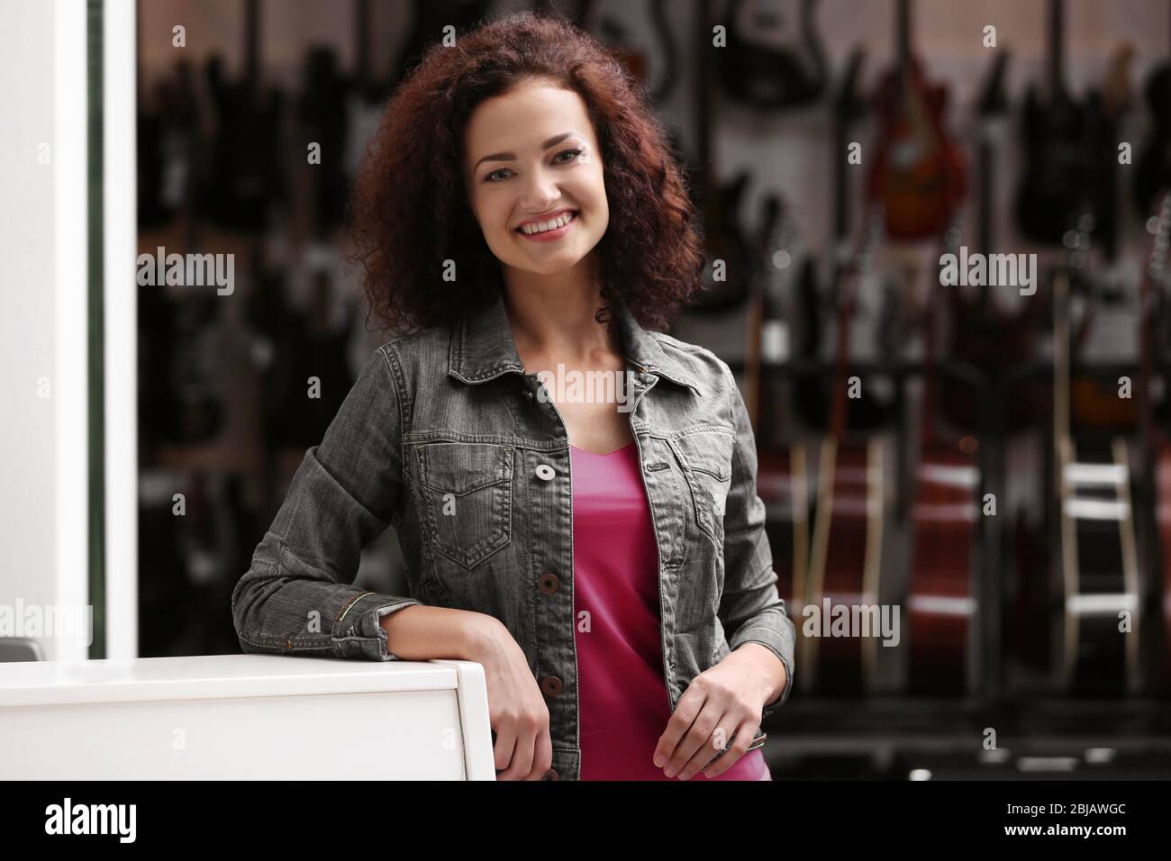 Beautiful girl in music shop Stock Photo - Alamy